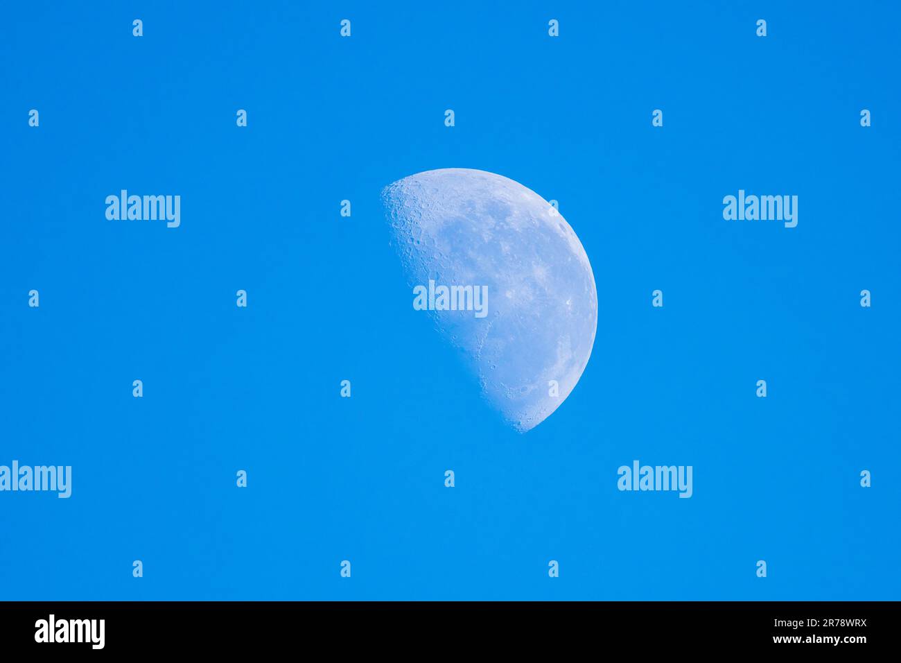Partial moon in the blue daytime sky over Mallacoota, Victoria ...