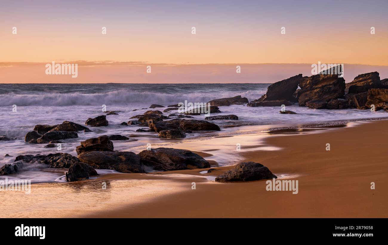 Sunrise seascape with large waves washing ashore at Killcare Beach on ...