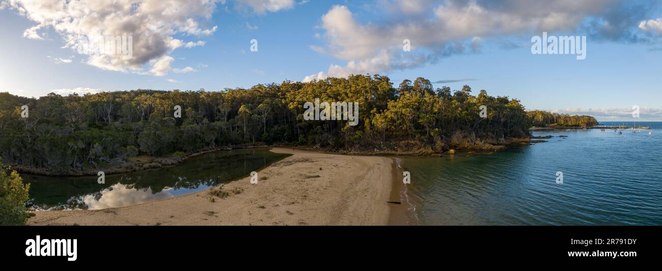White clouds in a blue sky over the ocean at Nullica Bay, Twofold Bay ...