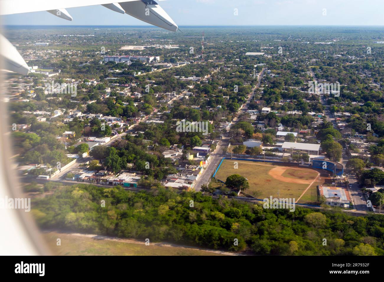 Oblique aerial view from plane of baseball pitche and suburban housing ...