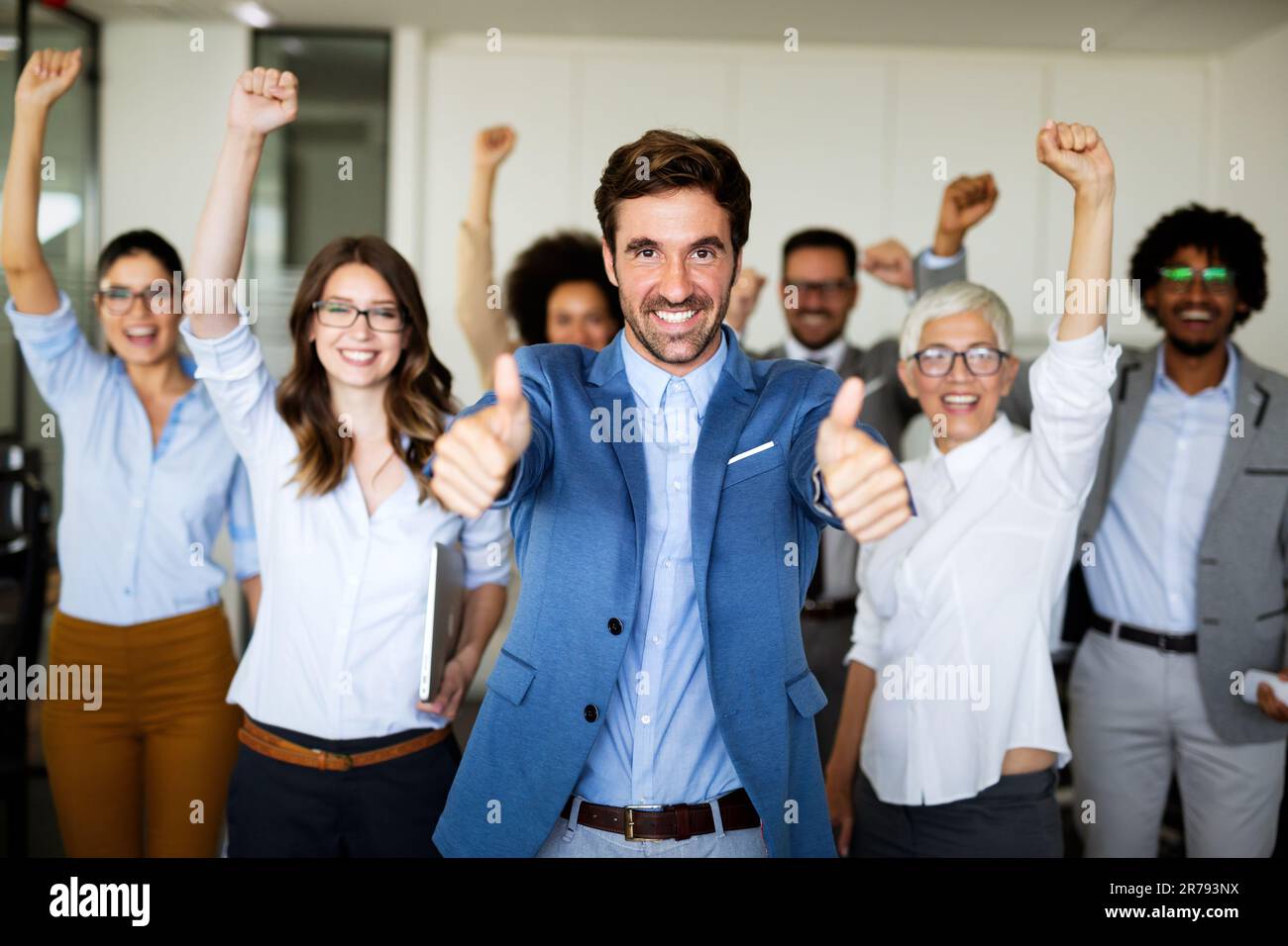 Group of successful multiethnic business people celebrating a good job ...