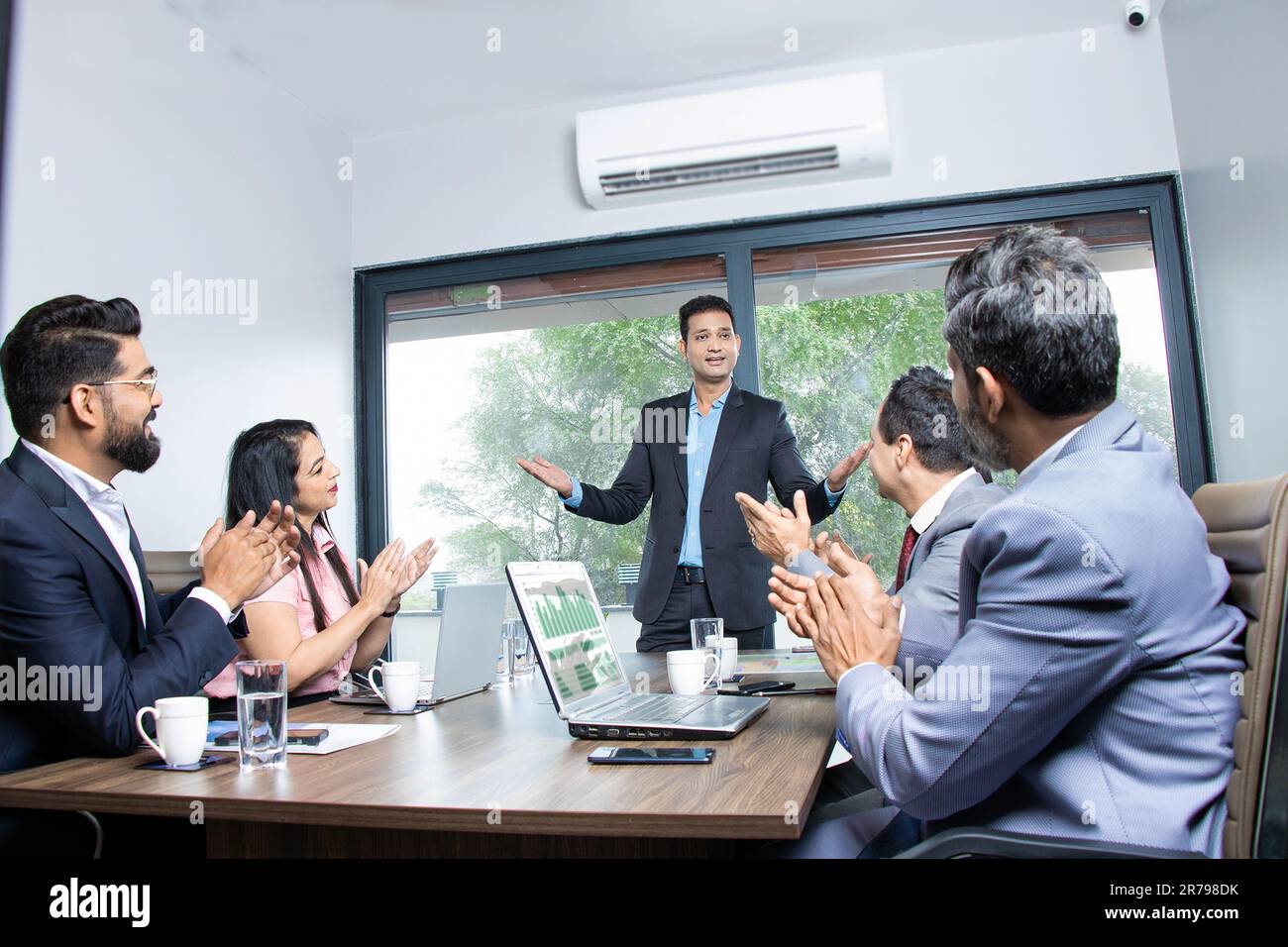 Indian businesspeople clapping and appreciating businessman at ...