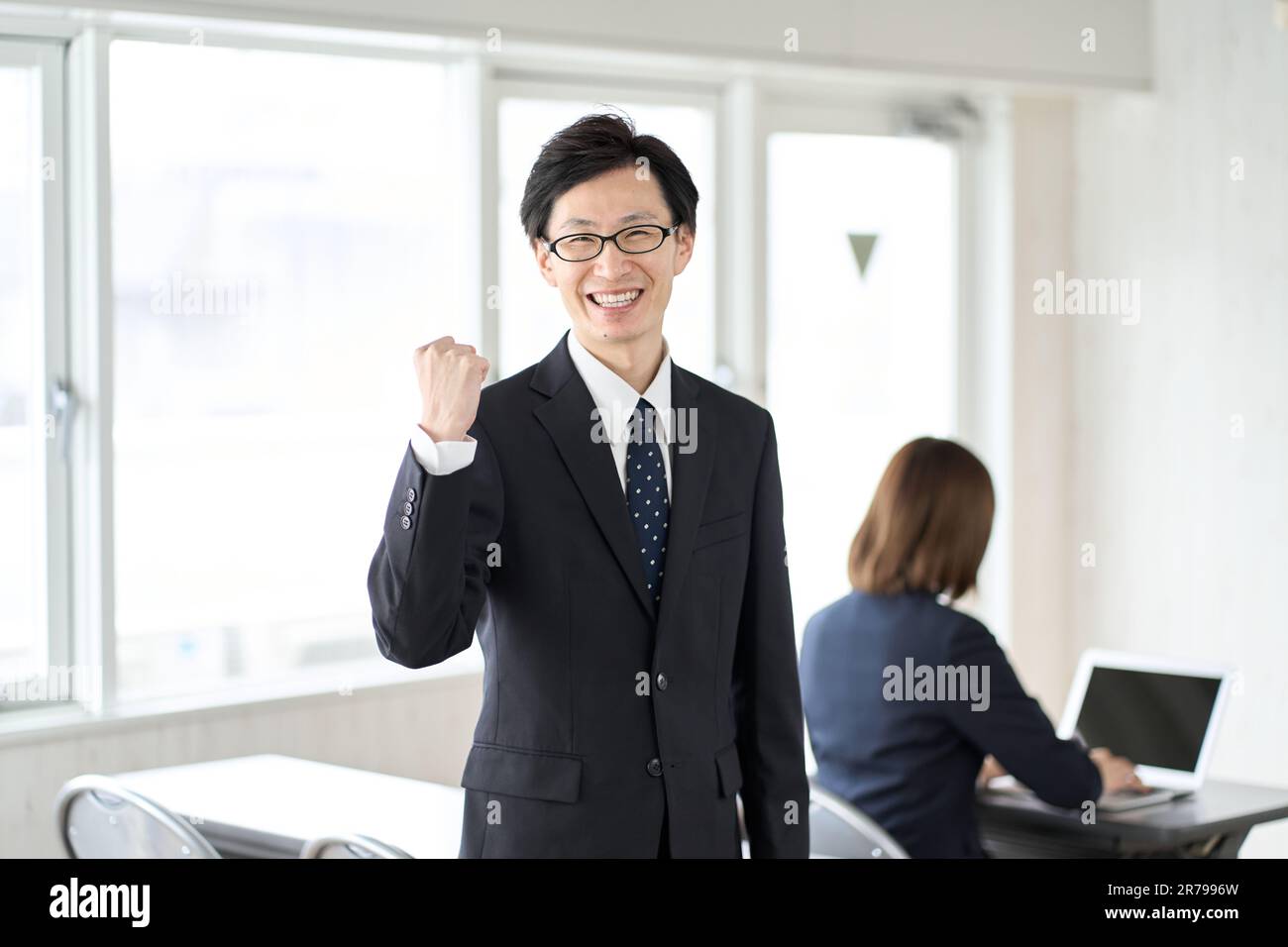 Asian businessman doing fist pose in seminar room Stock Photo - Alamy