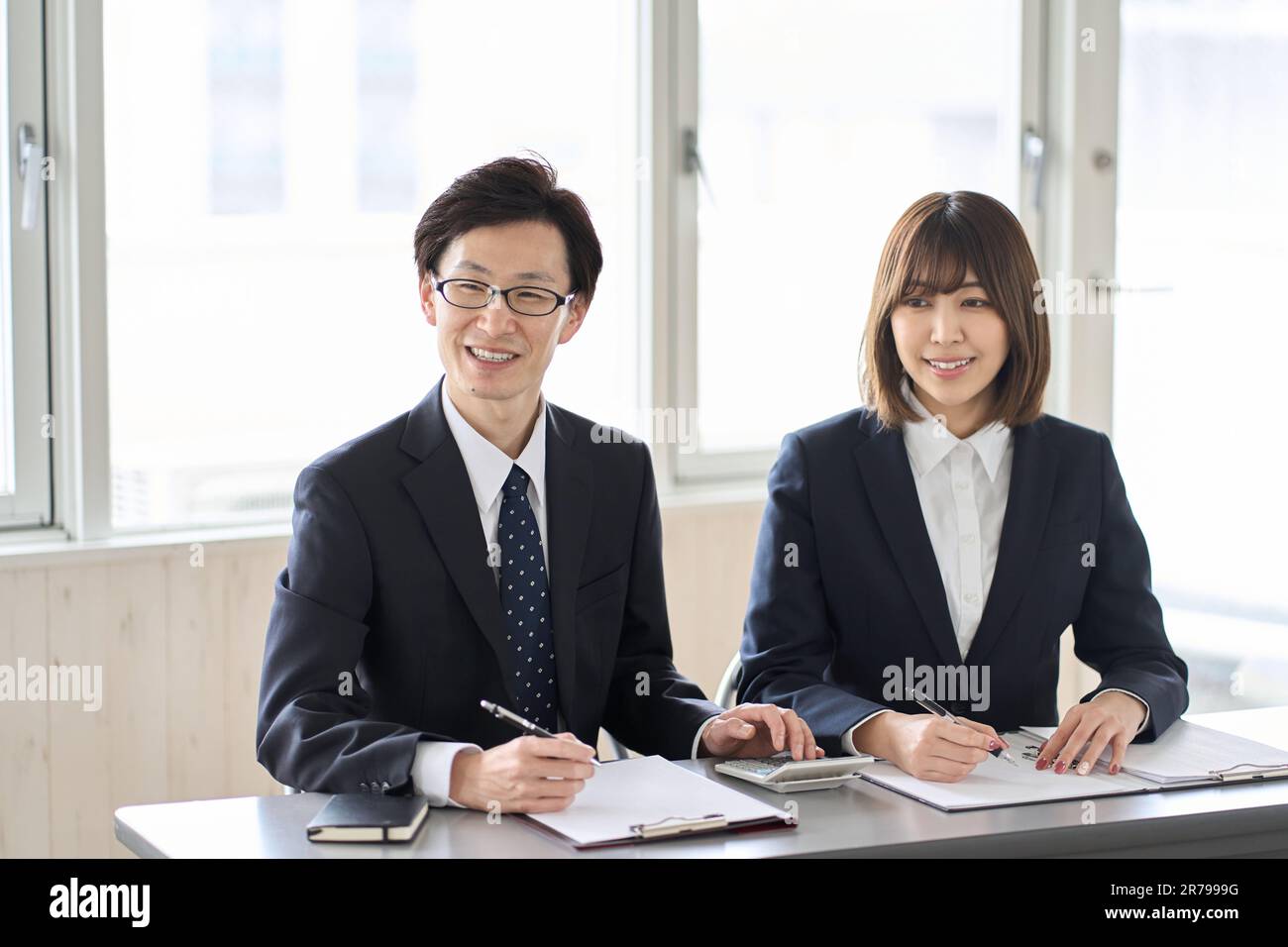 An Asian professional conducting a hearing Stock Photo - Alamy