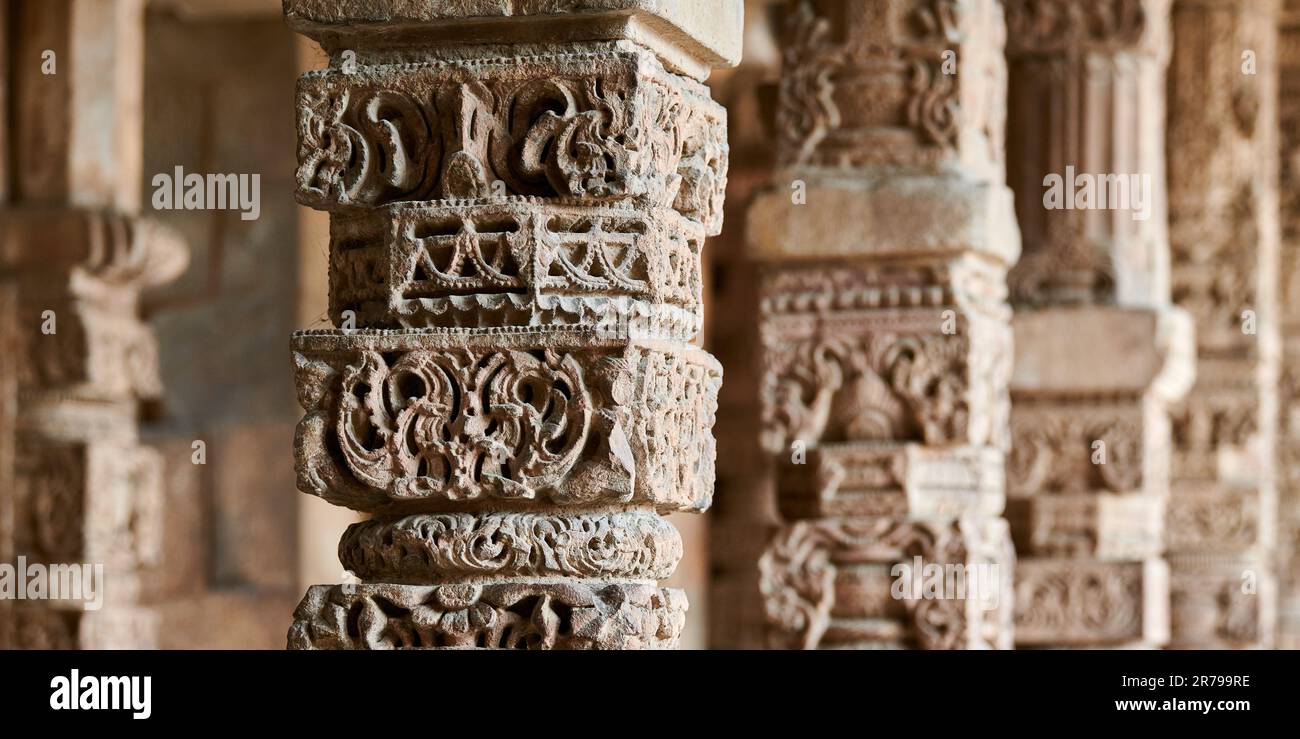 Stone columns with decorative bas relief of Qutb complex in South Delhi ...