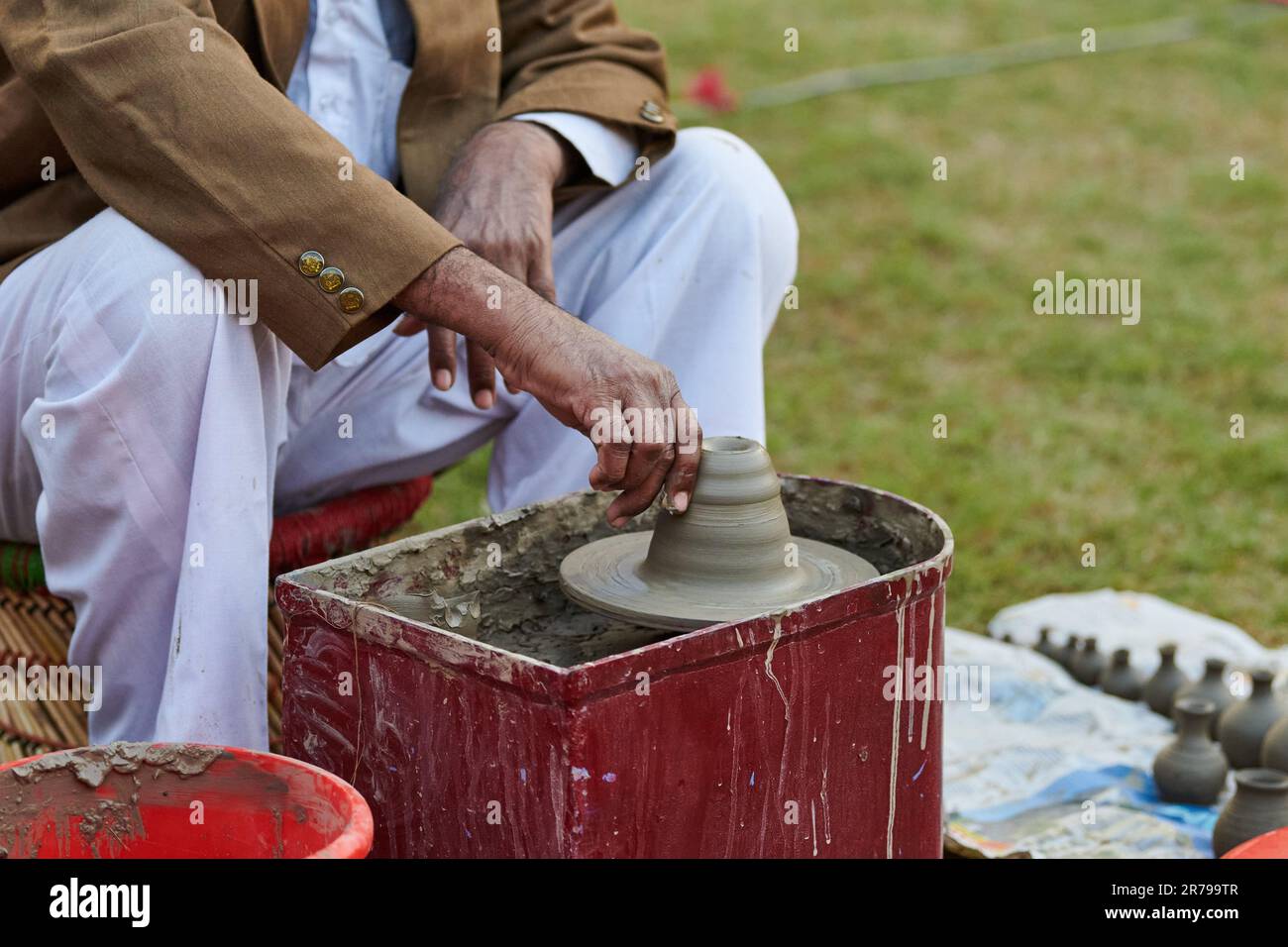 Close up old indian man hand makes pottery items from clay, old potter ...