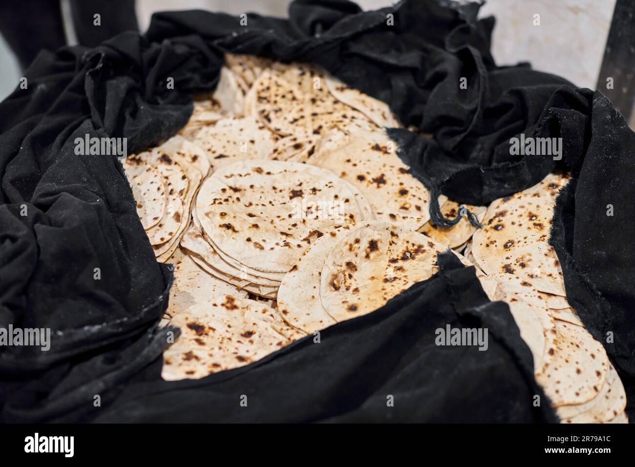 Batch of chapati round flatbreads in black bag for langar in sikh ...