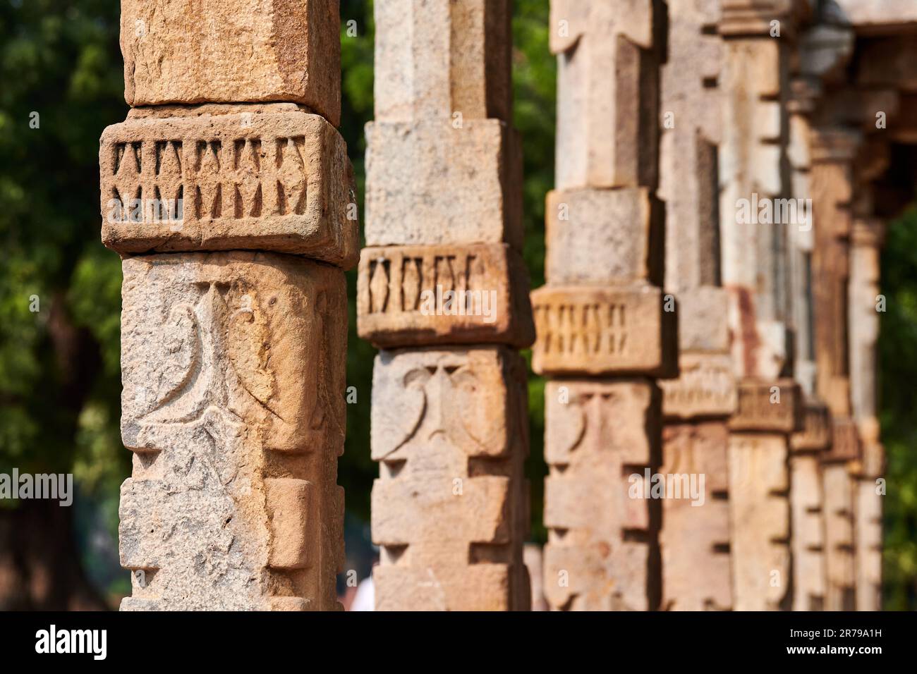 Stone columns with decorative bas relief of Qutb complex in South Delhi ...