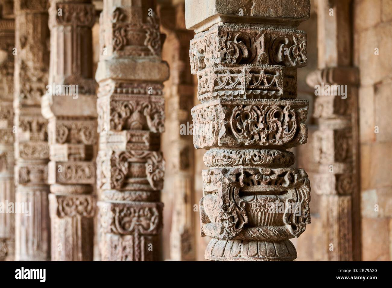 Stone columns with decorative bas relief of Qutb complex in South Delhi ...