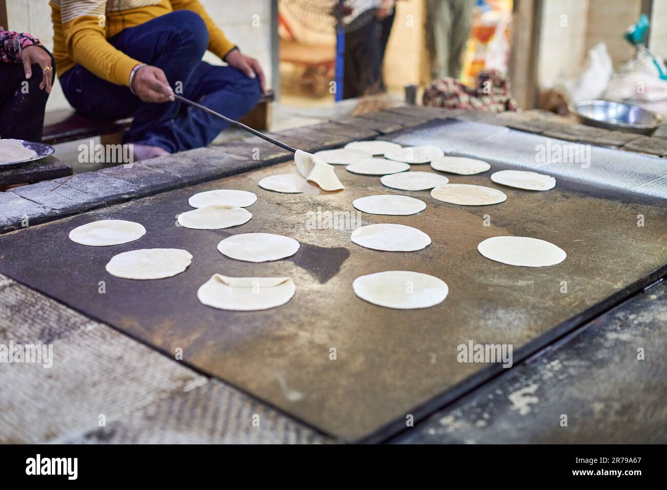 Cooking of chapati round flatbreads for langar in sikh gurudwara temple ...