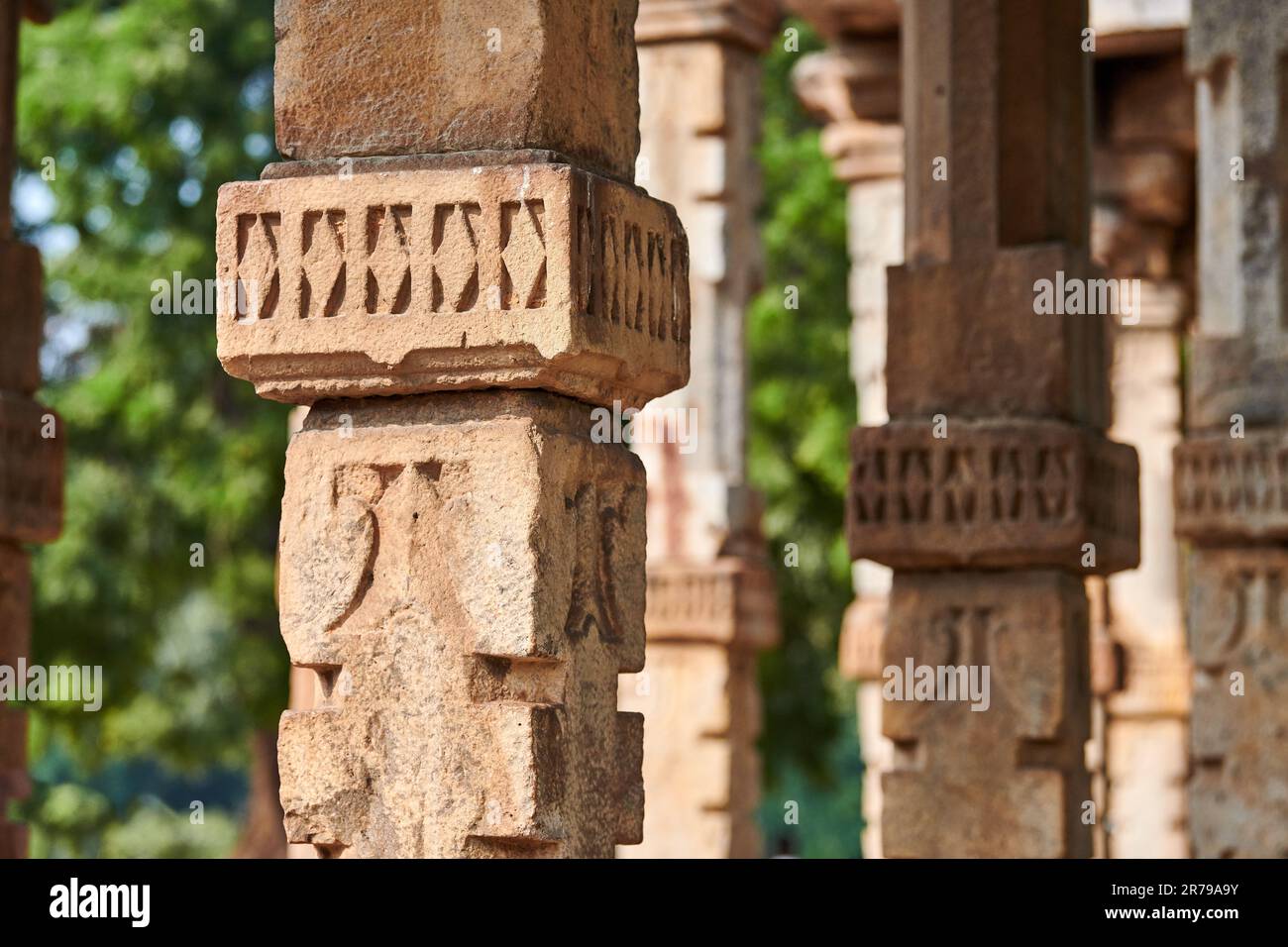 Stone columns with decorative bas relief of Qutb complex in South Delhi ...