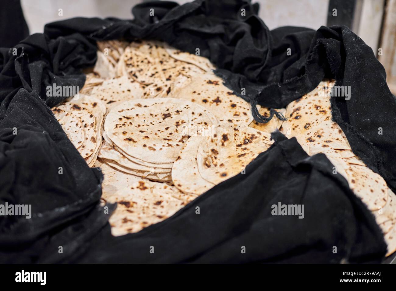 Batch of chapati round flatbreads in black bag for langar in sikh ...