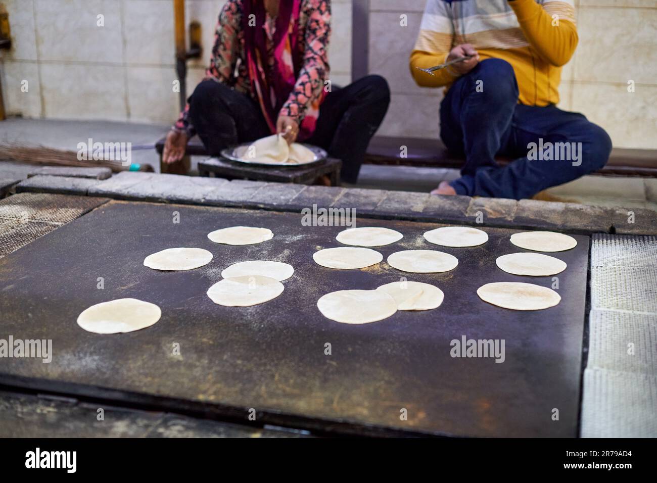 Cooking of chapati round flatbreads for langar in sikh gurudwara temple ...