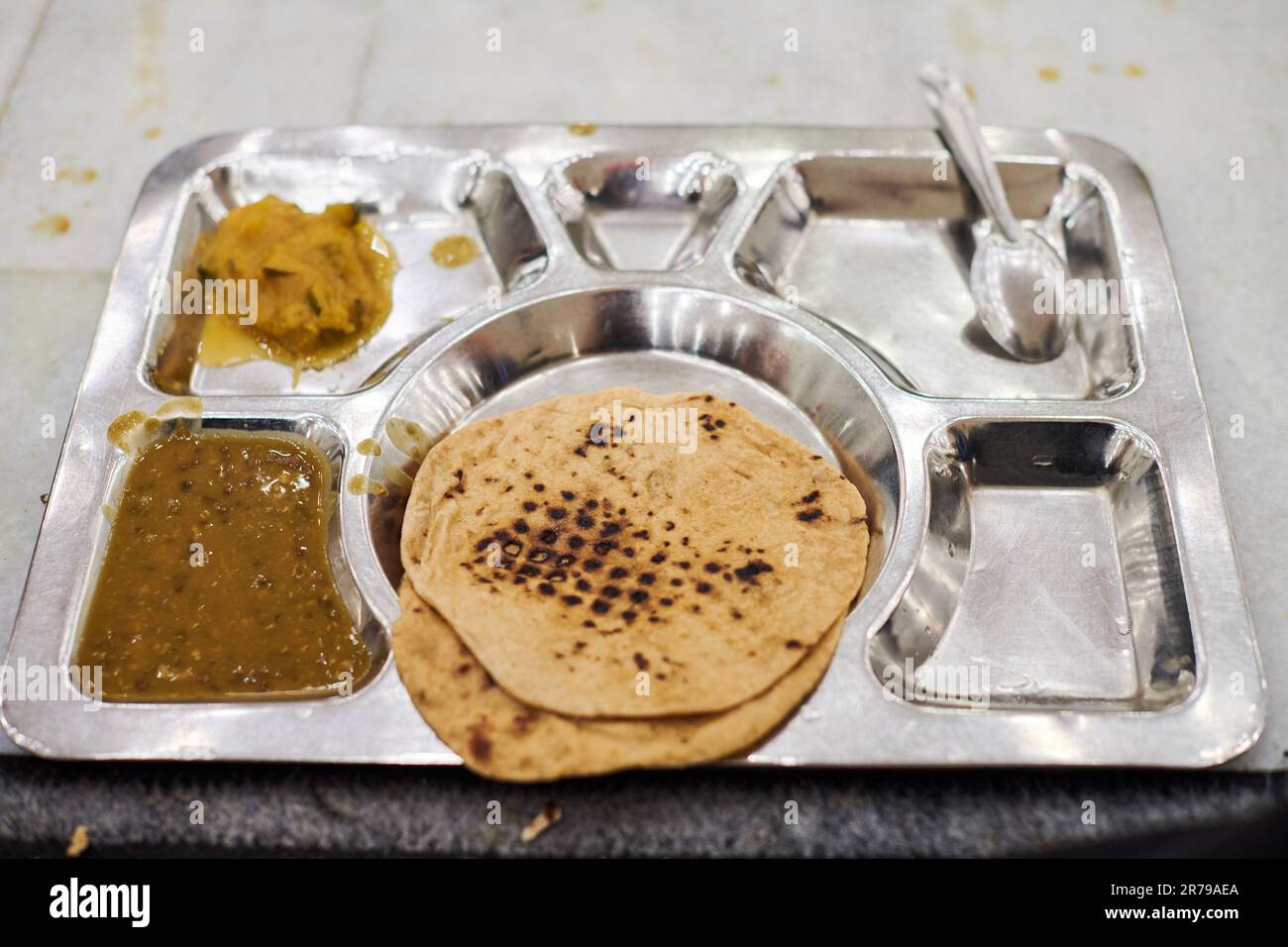 Silver tray with chapati, dal and sabji vegetable puree free food for ...