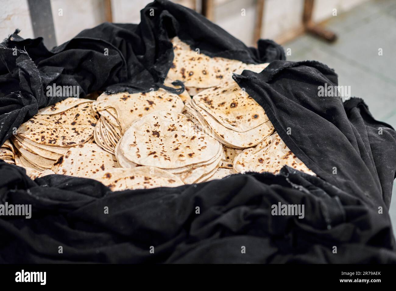 Batch of chapati round flatbreads in black bag for langar in sikh ...
