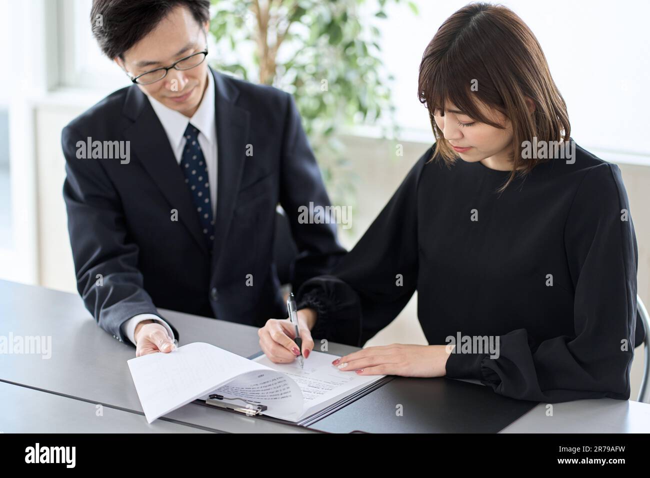 Asian woman signing business contract hi-res stock photography and ...