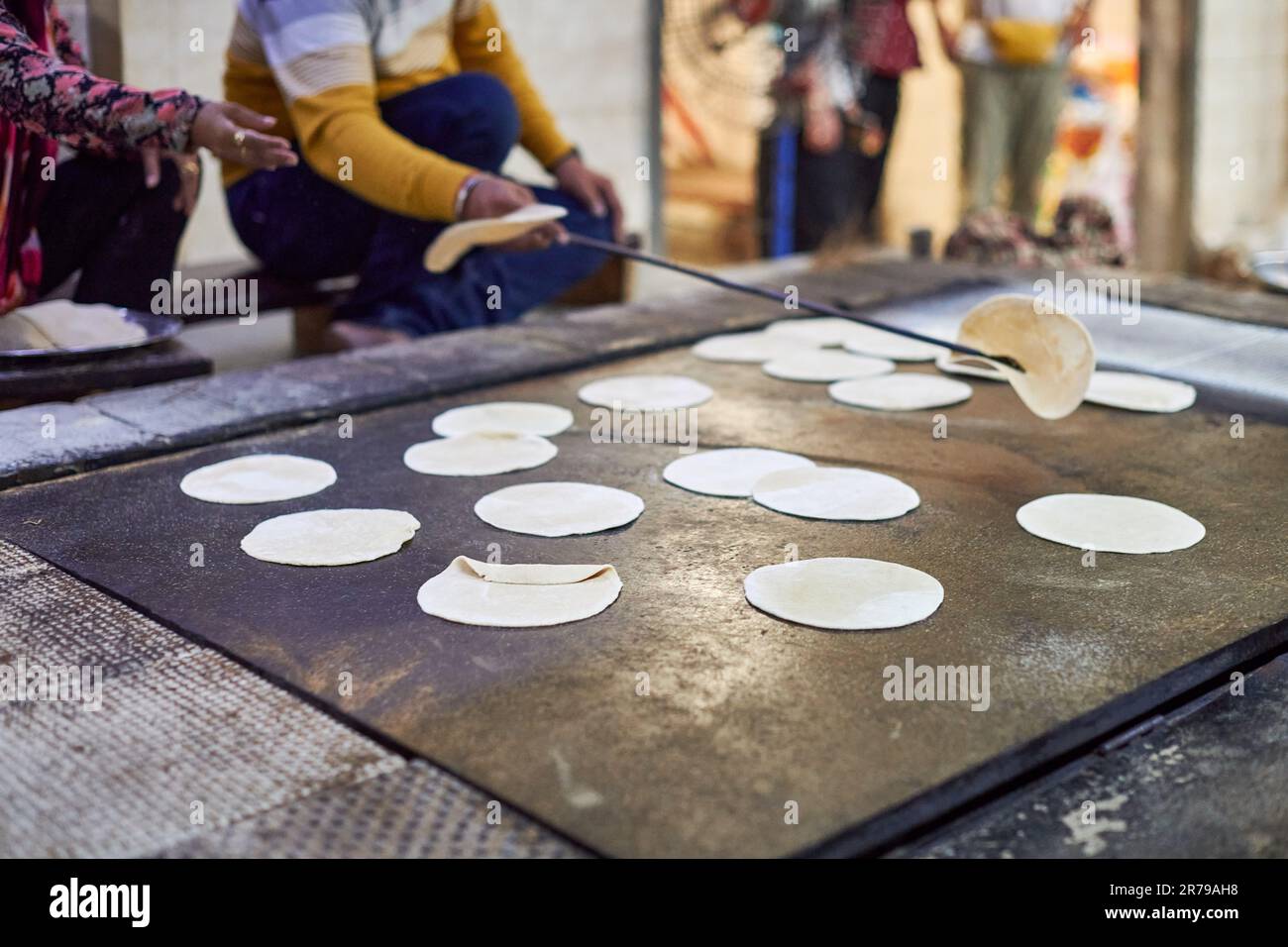 Cooking of chapati round flatbreads for langar in sikh gurudwara temple ...