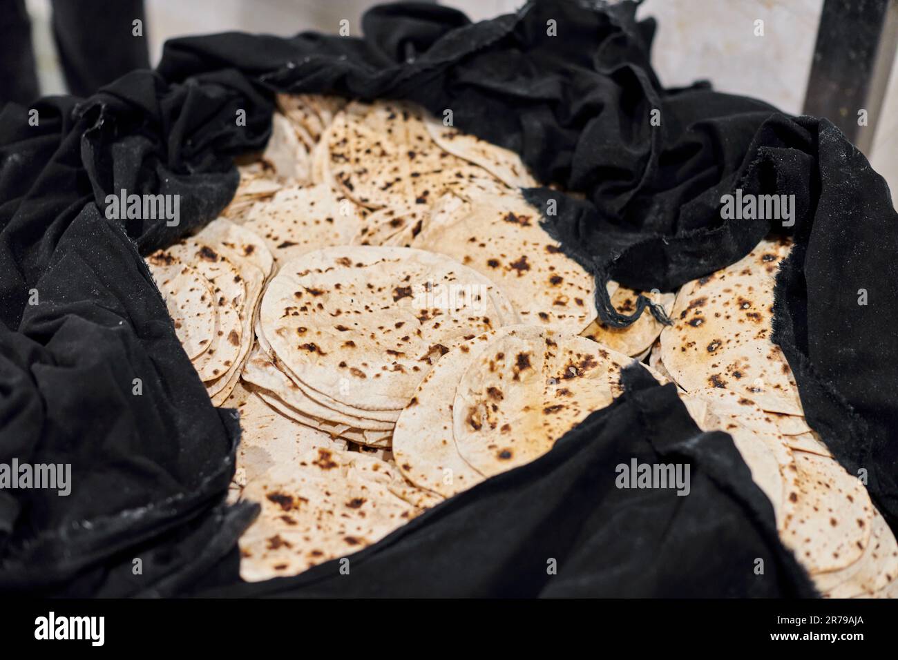 Batch of chapati round flatbreads in black bag for langar in sikh ...