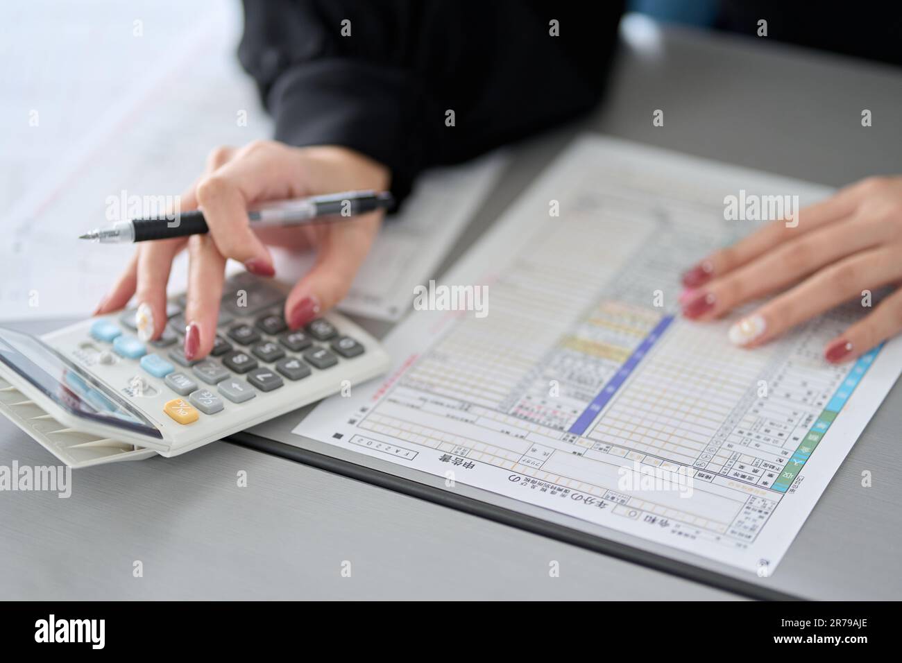 Asian woman preparing tax return documents Stock Photo - Alamy