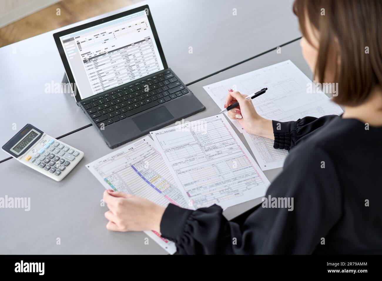 Asian woman preparing tax return documents Stock Photo - Alamy