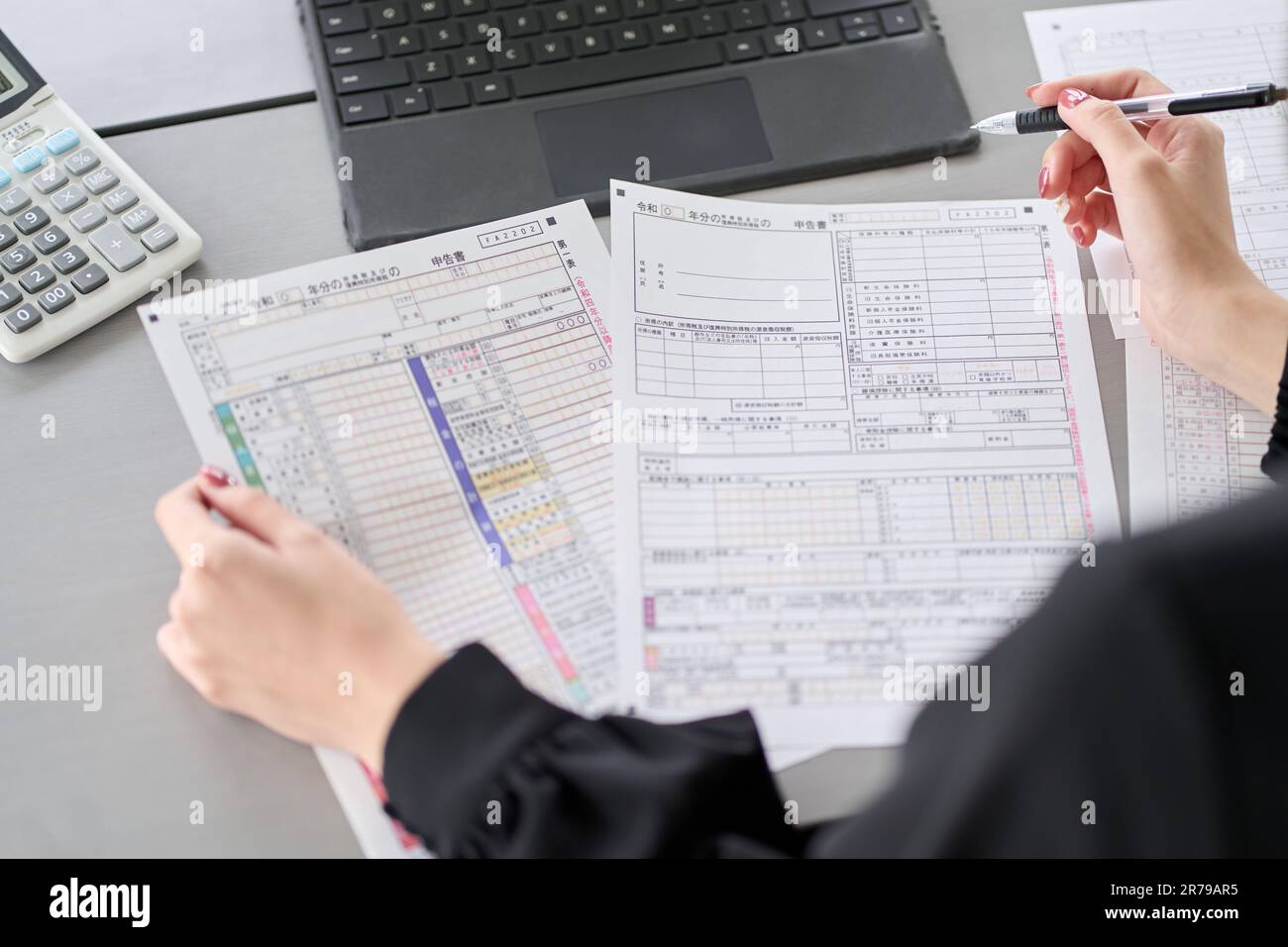 Asian woman preparing tax return documents Stock Photo - Alamy