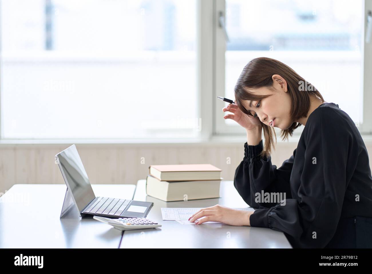 Worried woman calculator office hi-res stock photography and images - Alamy