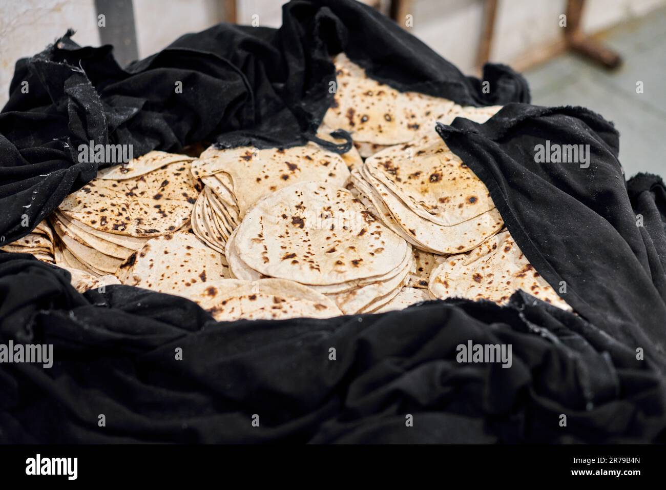 Batch of chapati round flatbreads in black bag for langar in sikh ...