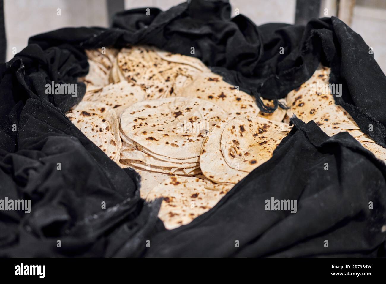 Batch of chapati round flatbreads in black bag for langar in sikh ...