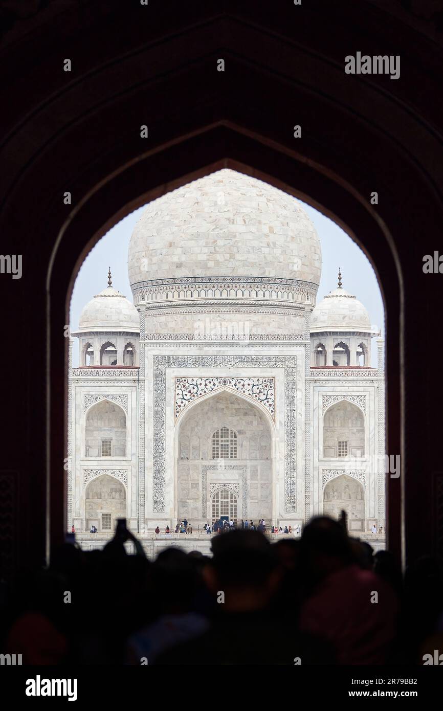 Archway of main gateway in Taj Mahal entrance with tourists silhouettes ...