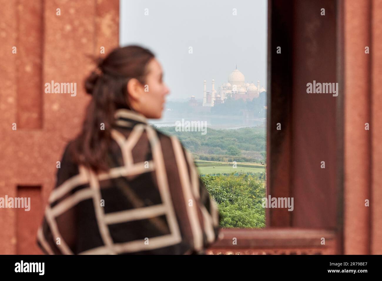 Rear view east asian woman in black dress look at Taj Mahal through ...