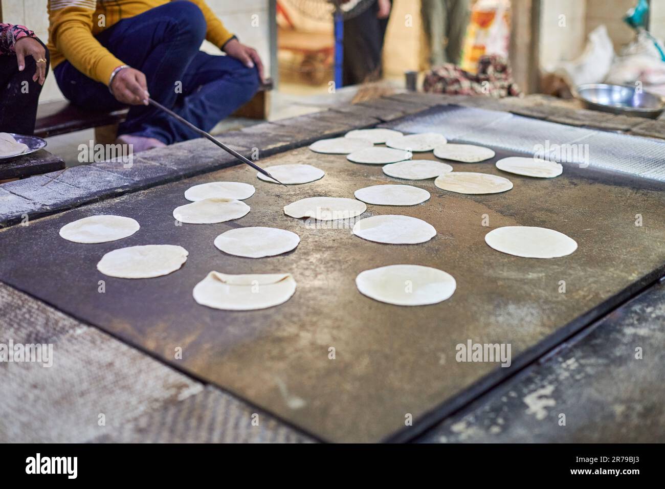 Cooking of chapati round flatbreads for langar in sikh gurudwara temple ...