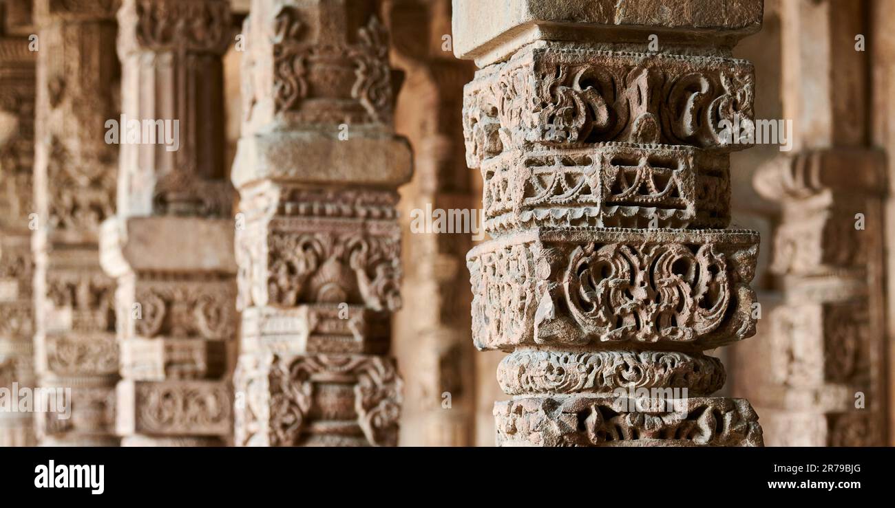 Stone columns with decorative bas relief of Qutb complex in South Delhi ...