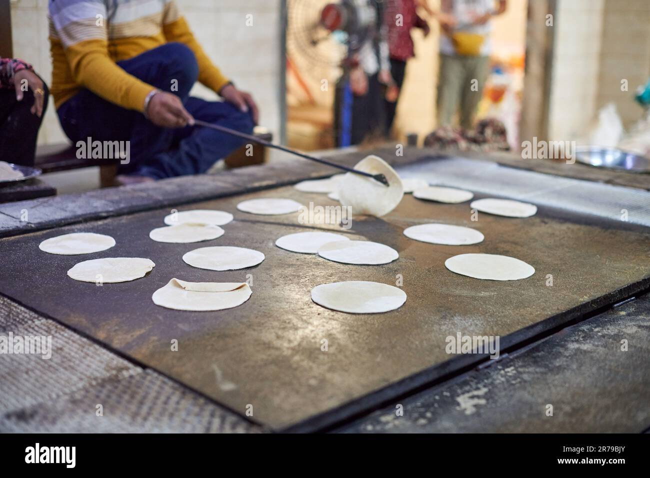Cooking of chapati round flatbreads for langar in sikh gurudwara temple ...