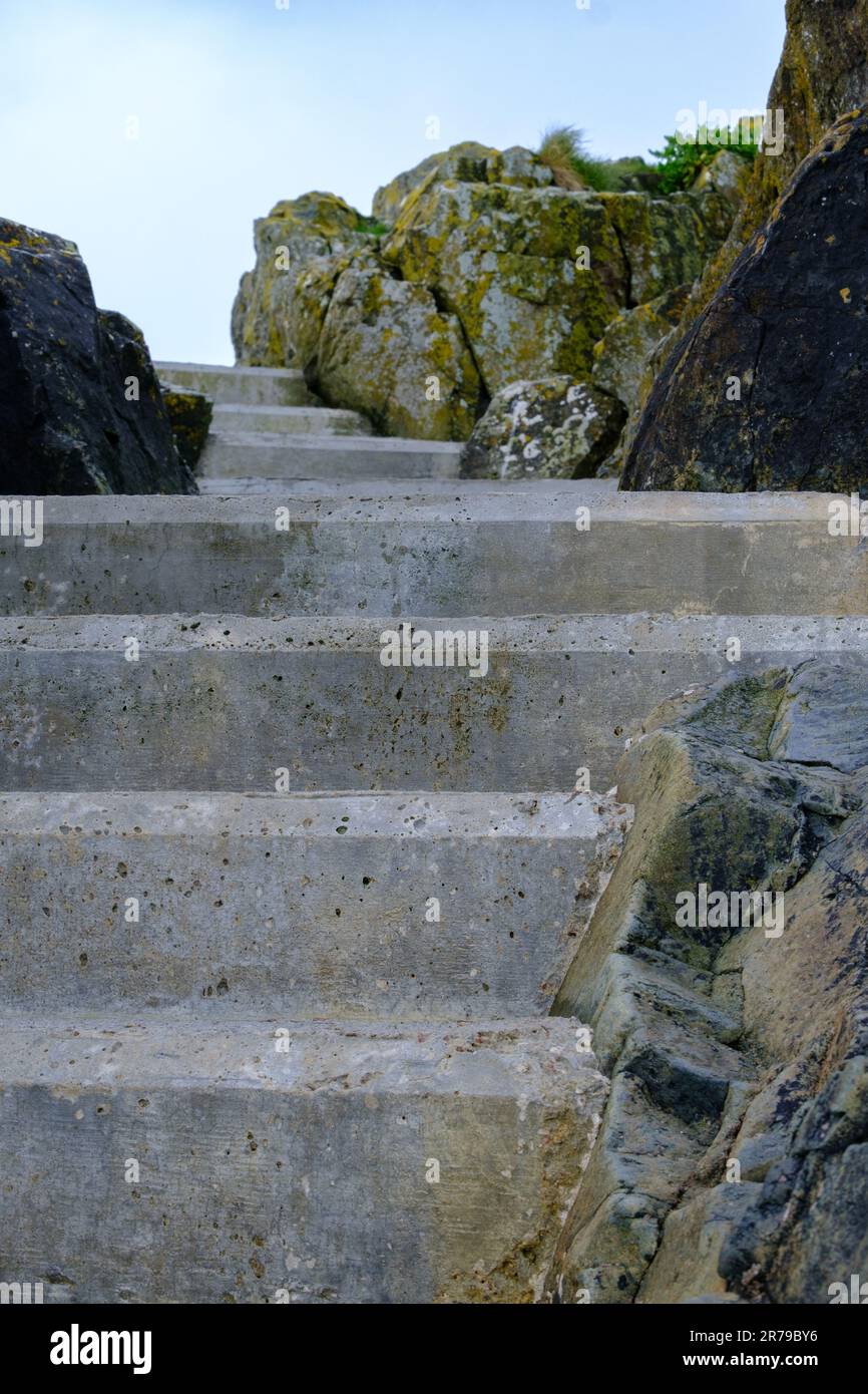 Concrete steps with rocks on both sides at Marazion Beach, Cornwall ...