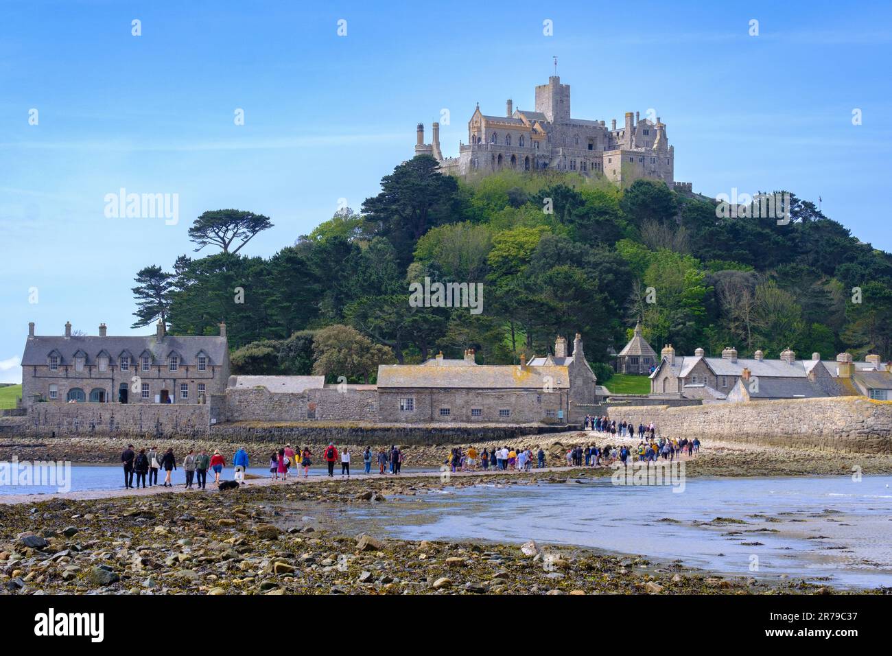 People walk on the causeway during low tide to St Michael’s Mount ...