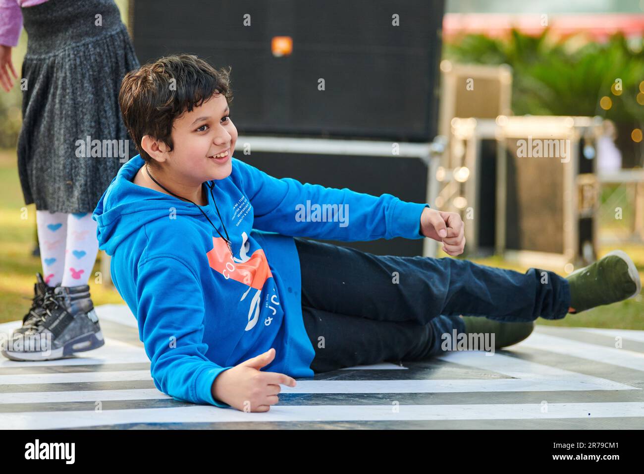 New Delhi, India - 10.12.2022 - Little boy dance to music at outdoor ...