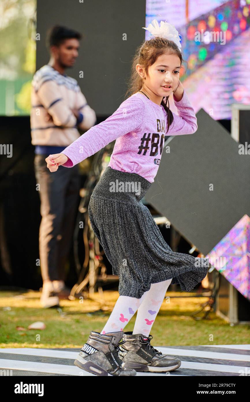 New Delhi, India - 10.12.2022 - Little girl dance to music at outdoor ...