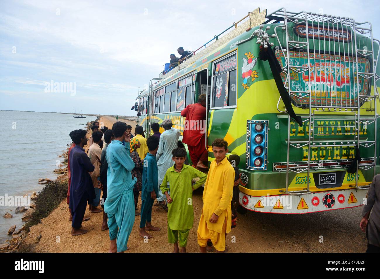 Thatta. 13th June, 2023. People board a bus as they evacuate from ...