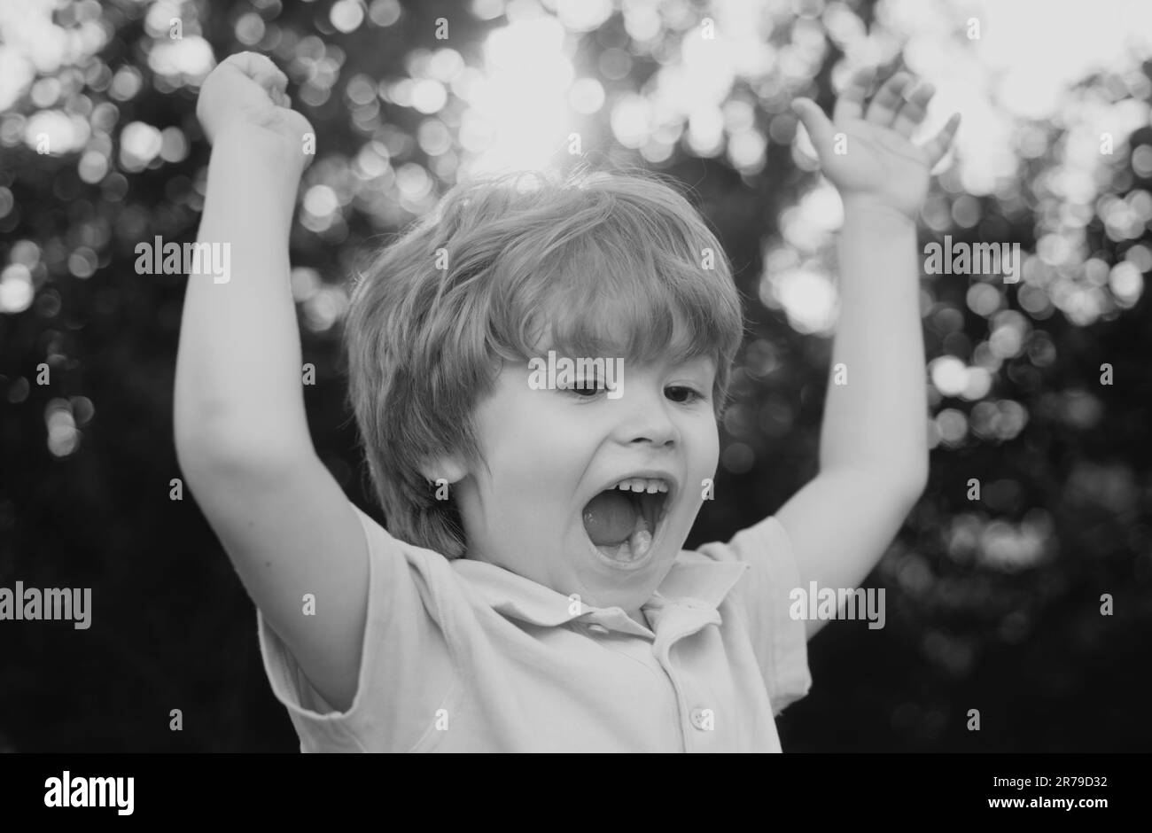 Excited kids. Portrait of adorable little boy on green background park ...