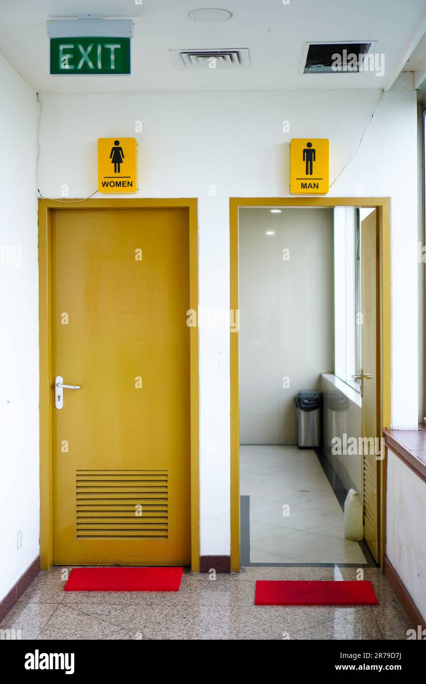 Yellow-colored restroom markers distinguishing men's and women's ...