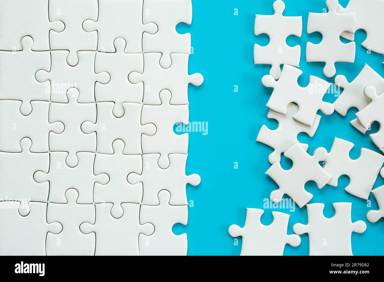 White part of jigsaw puzzle pieces on blue background. concepts of ...
