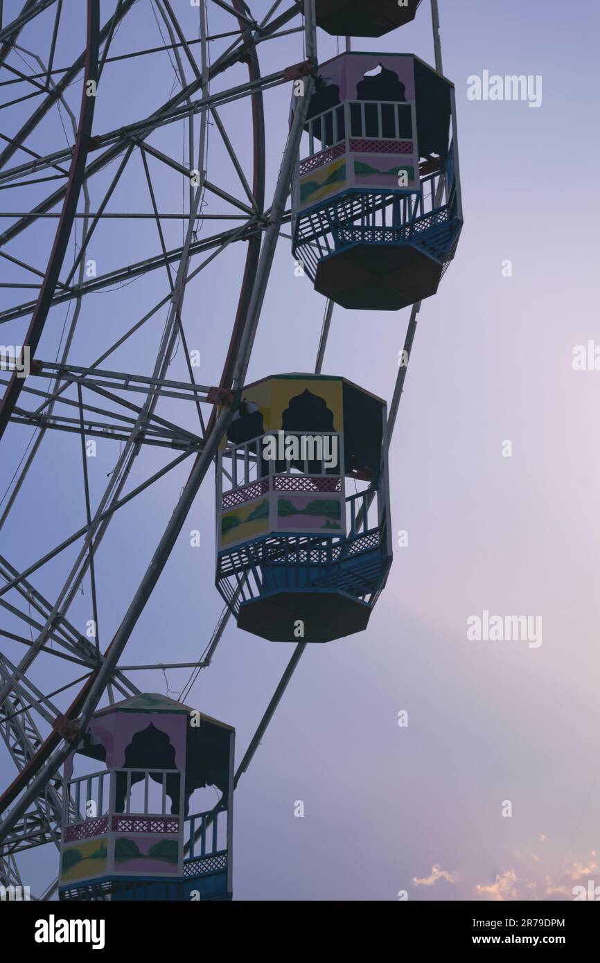 An aerial view of a large Ferris Wheel with two excited children inside ...