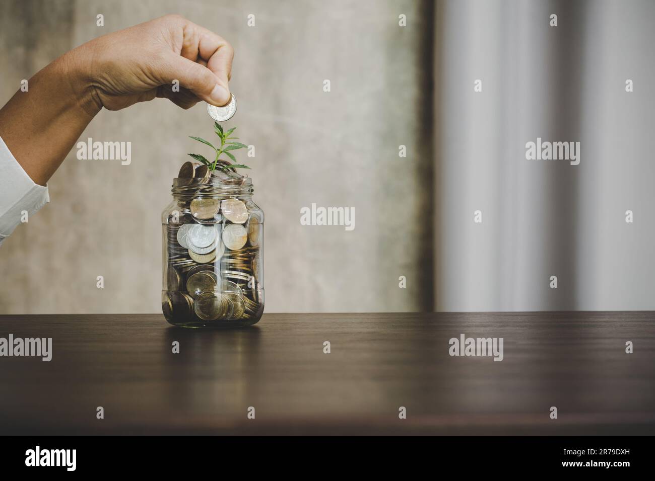 Businessman putting coin in glass hi-res stock photography and images ...