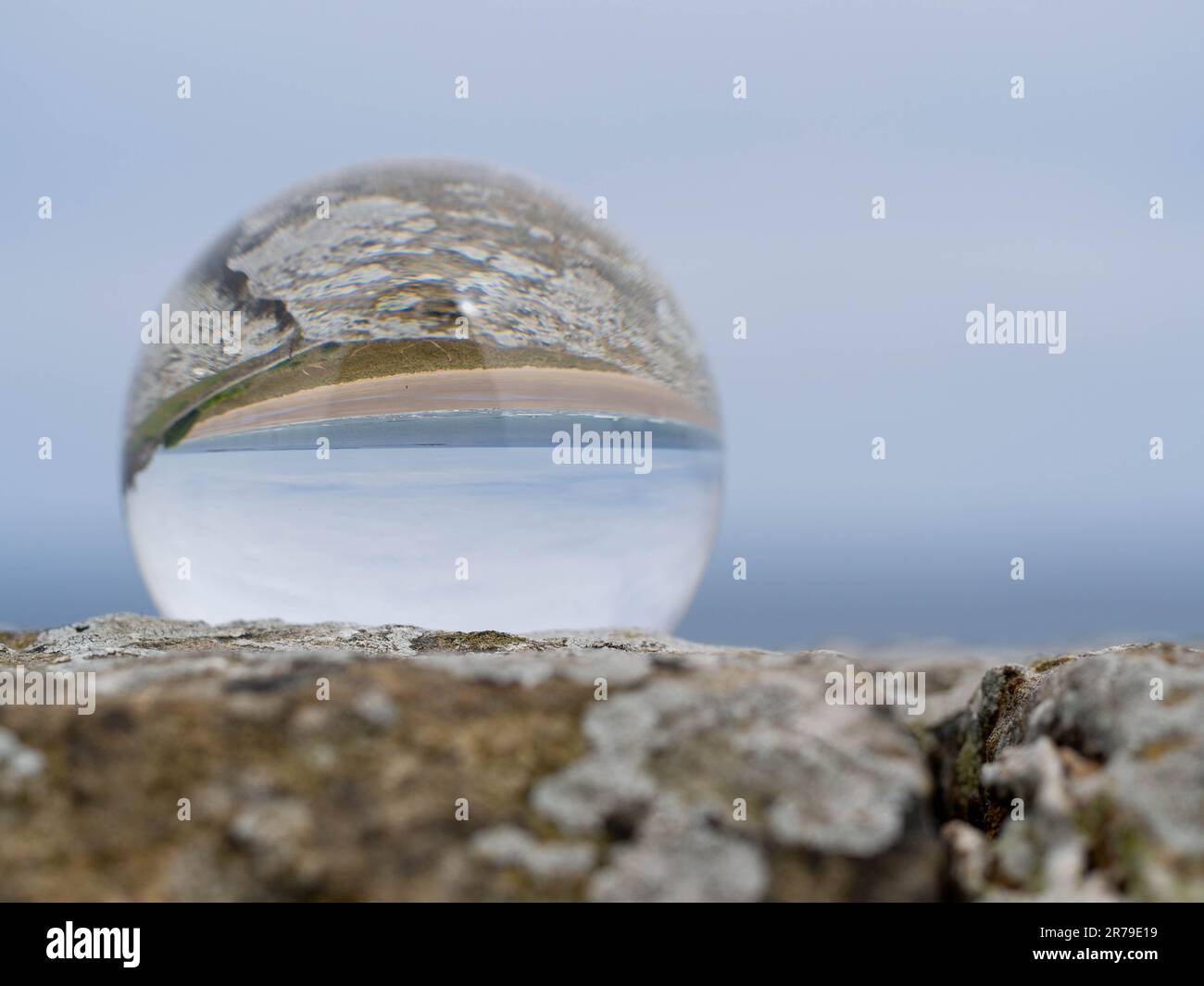 Bamburgh Beach reflected in a lens ball, on the castle wall Stock Photo ...