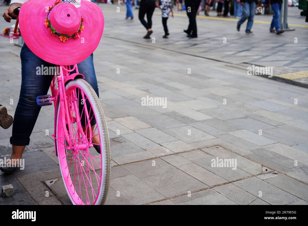 Woman riding beautiful pink ontel bicycle with aesthetic pink hat ...