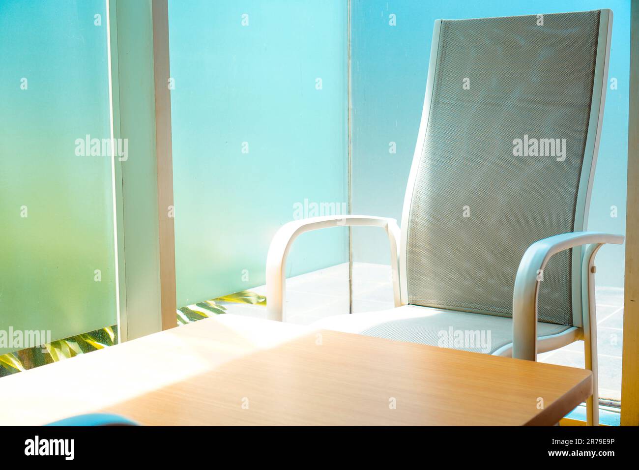 White minimalist chairs and wooden table set against a backdrop of ...