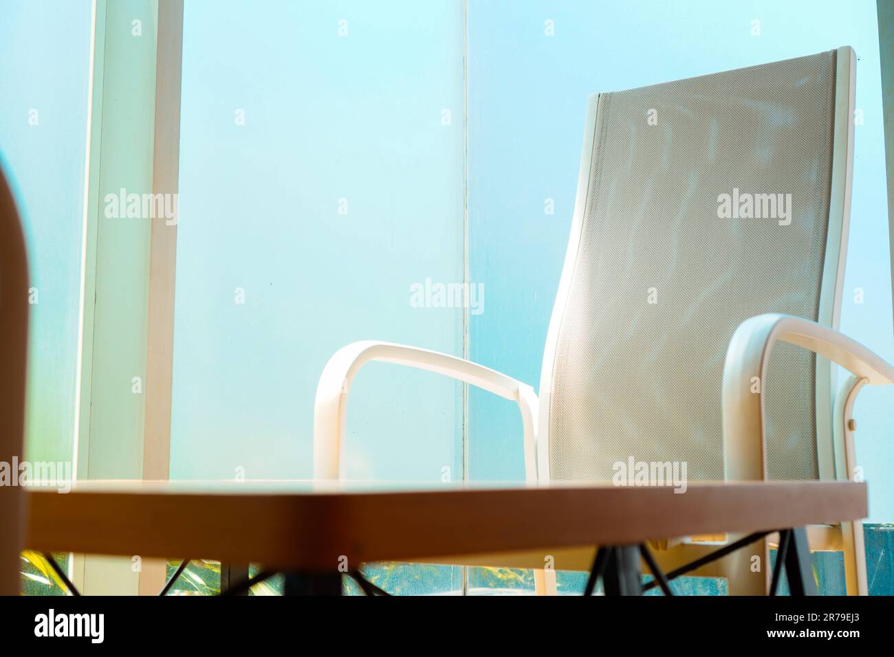 White minimalist chairs and wooden table set against a backdrop of ...