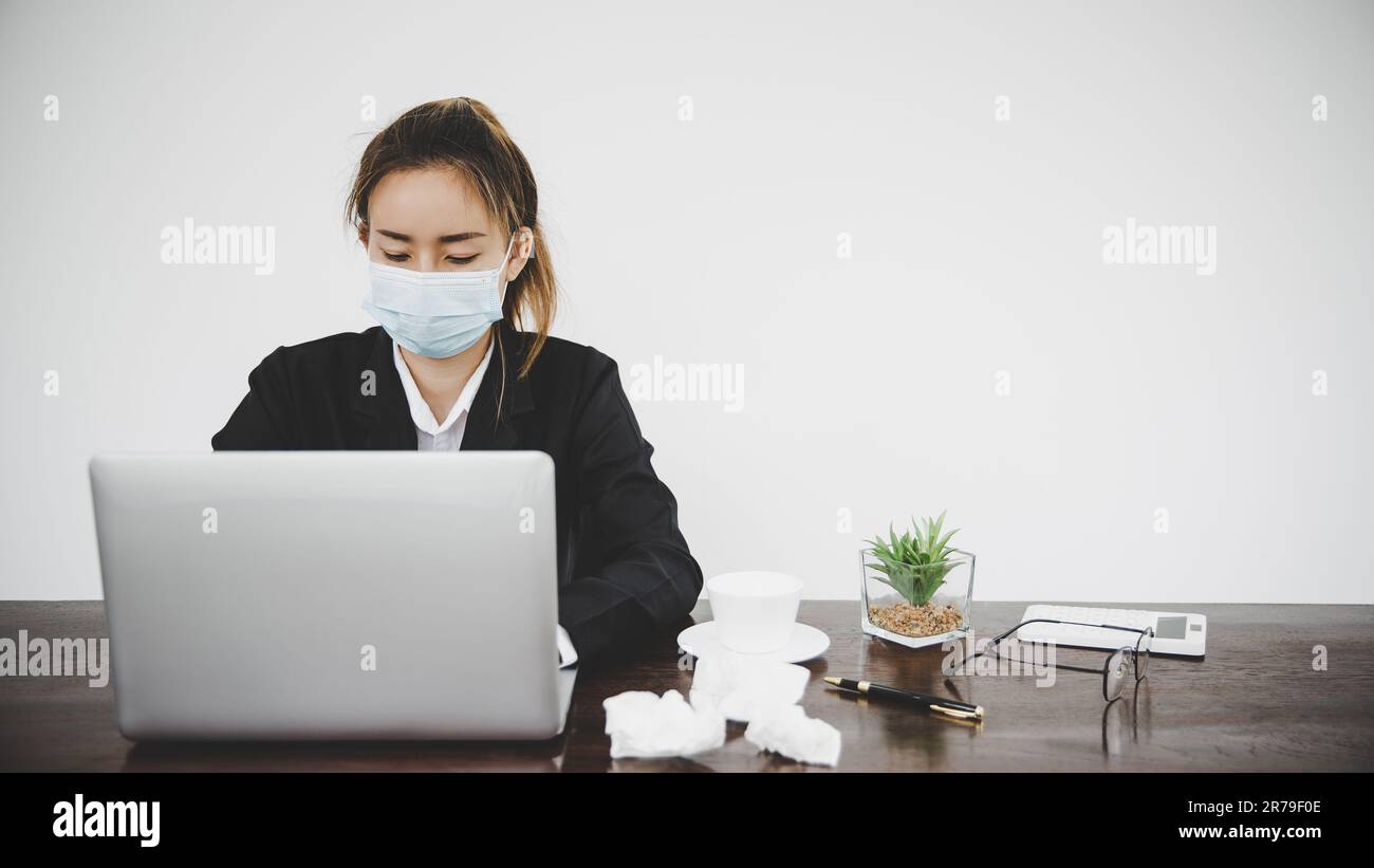 Sick young asian business woman wearing protective face mask having ... Sick young asian business woman wearing protective face mask having ...