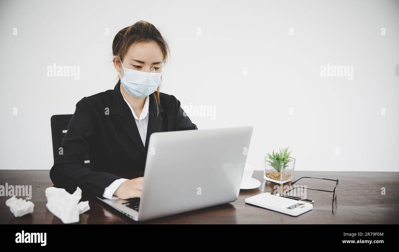 Sick young asian business woman wearing protective face mask having ... Sick young asian business woman wearing protective face mask having ...