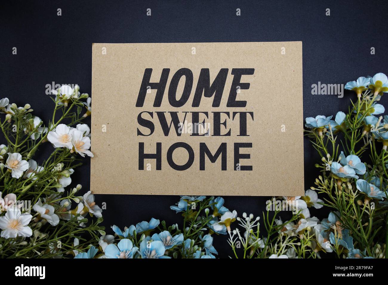 Home Sweet Home text message with flower decoration on black background ...